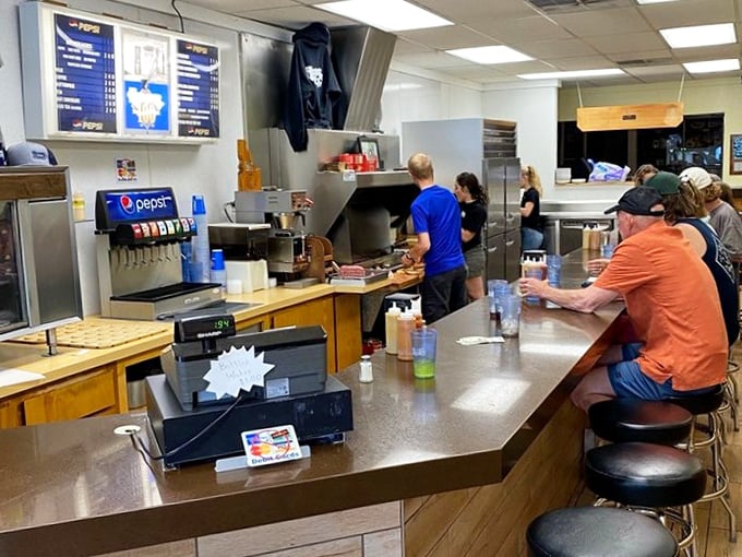 The counter view&mdash;where strangers become temporary friends united by the universal language of exceptional burgers. 