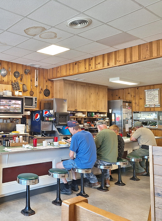 Counter seating where locals solve world problems over coffee and pie. These stools have supported more wisdom than most university lecture halls.
