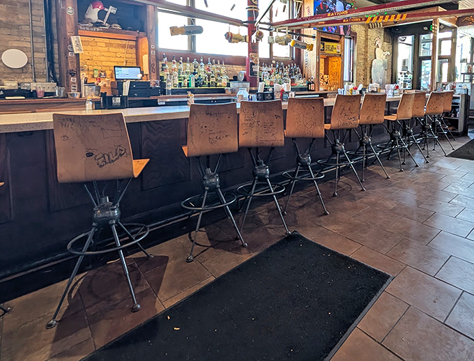 Bar seating with character&mdash;each stool tells a story through carved initials and messages from diners past, present, and future. 