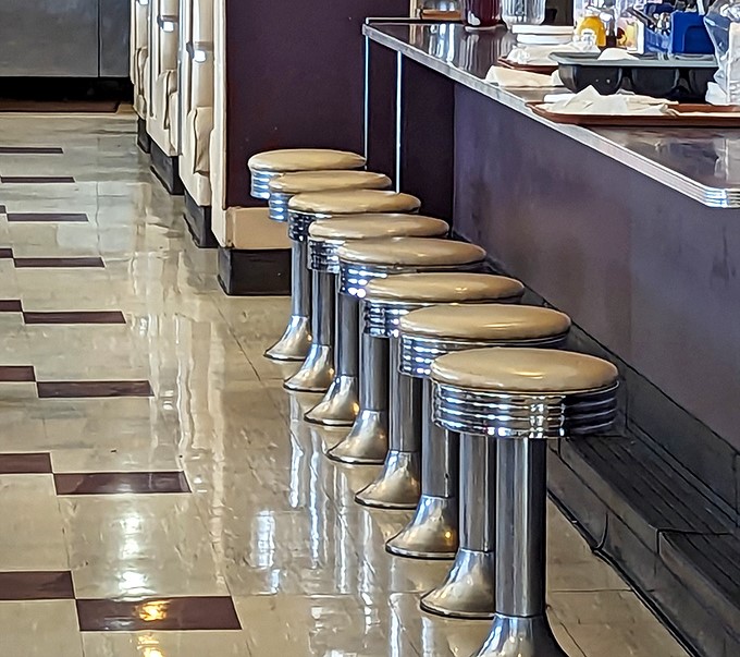 Chrome counter stools lined up like soldiers, ready for hungry patrons to perch and feast.