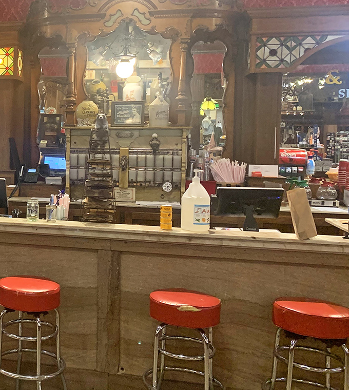 Vintage elegance meets country charm at this counter, where red stools invite you to perch and watch the bustling activity of a true Southern institution.