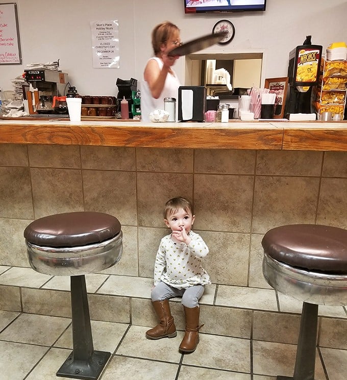 Where future food critics are born – this little one already knows the best seat in the house is at the counter.