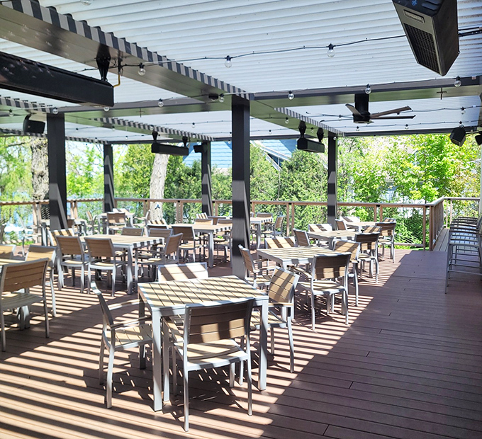 The covered patio offers al fresco dining without nature's surprises &ndash; sunshine without sunburn, breezes without blown napkins.