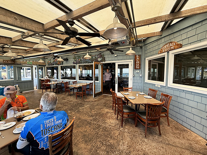 This covered patio offers shelter from coastal elements while still delivering that essential "I'm eating by the sea" experience we all crave.