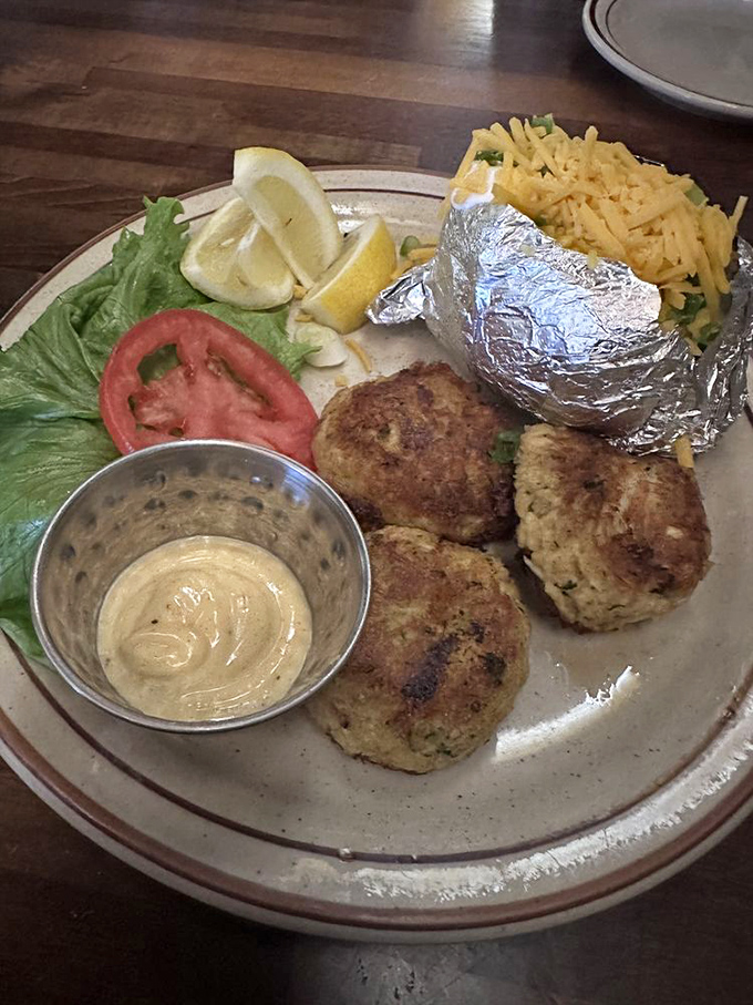 Crab cakes that respect the crab, with just enough binding to keep things interesting. That foil-wrapped potato is hiding delicious secrets.