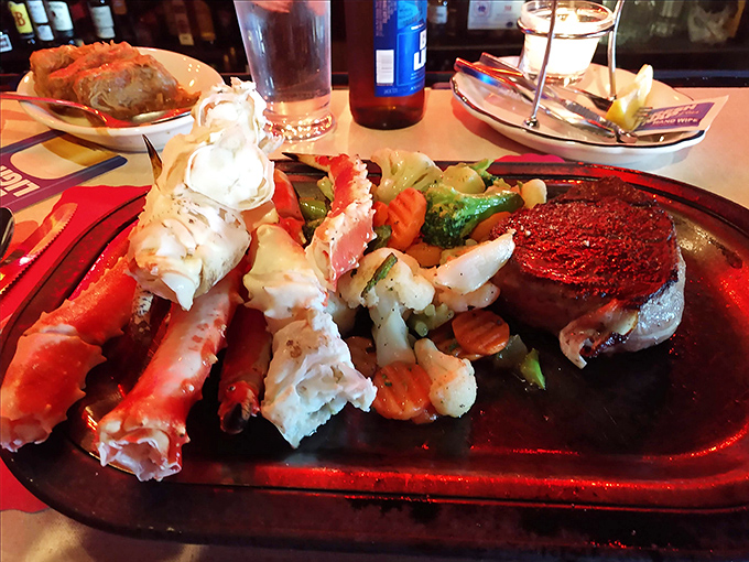 The surf meets turf in spectacular fashion: sweet crab legs and a perfectly cooked steak create the ultimate "why choose?" moment.