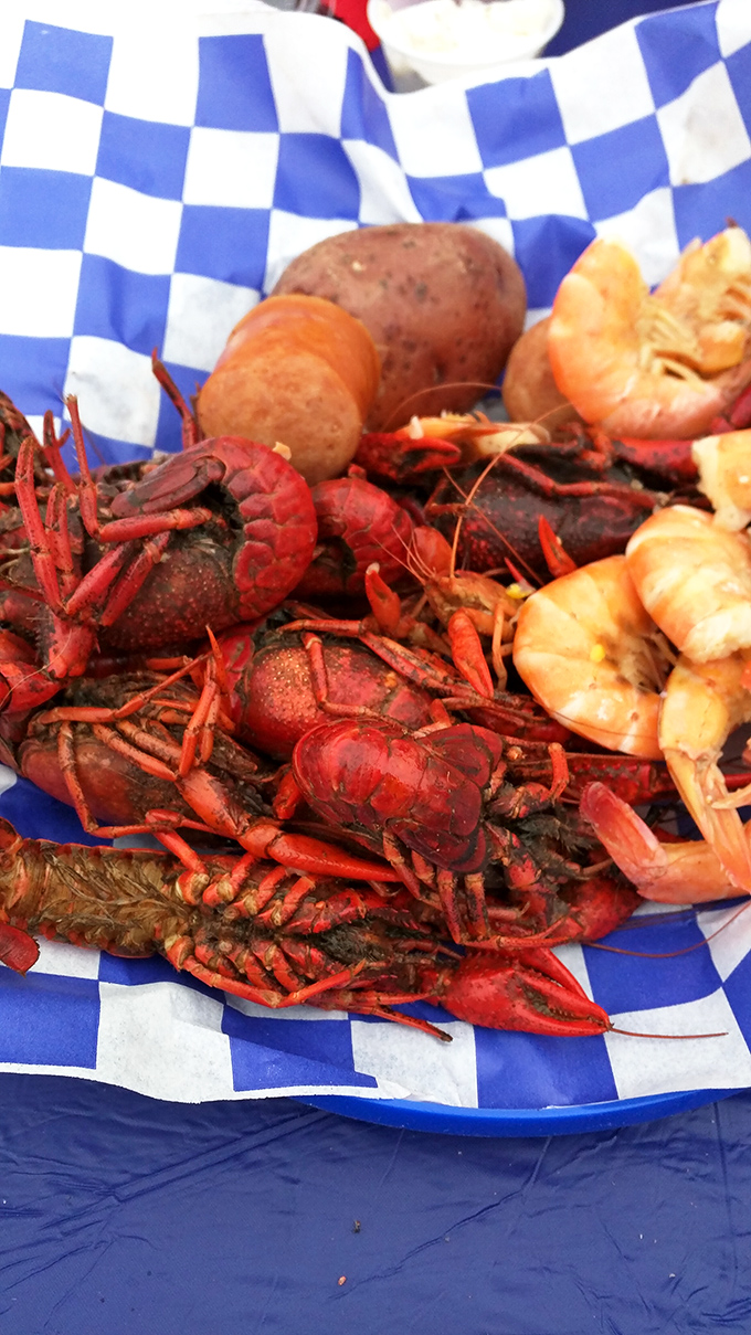 A blue-checkered paper cradles this crawfish boil like the Southern royalty it is—proof that inland waters can deliver coastal-worthy feasts.