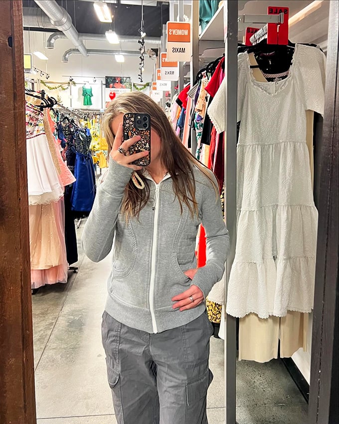 Industrial chic meets fashion forward. The exposed ceiling and modern displays create a boutique vibe that elevates the thrifting experience.