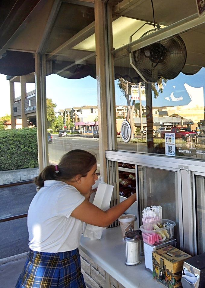 The time-honored ritual of the donut transaction&mdash;a moment of anticipation before that first heavenly bite that makes everything right with the world.