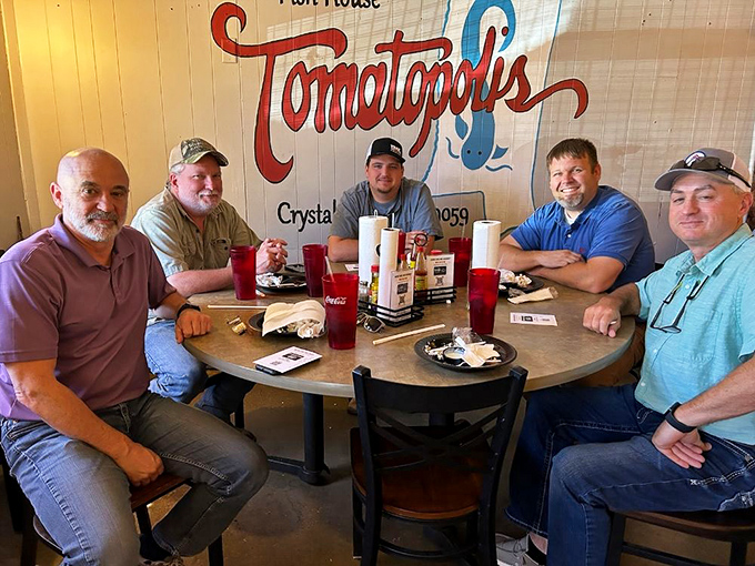 A table of satisfied diners proving that good food brings people together better than any social media platform ever could.