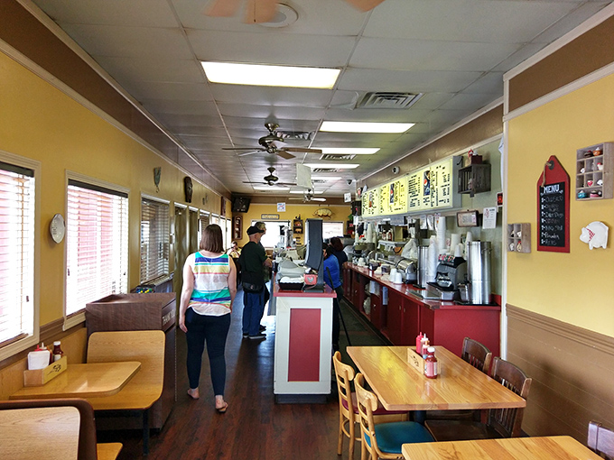 The narrow dining room creates an intimate experience where strangers become friends, united by the universal language of exceptional barbecue.