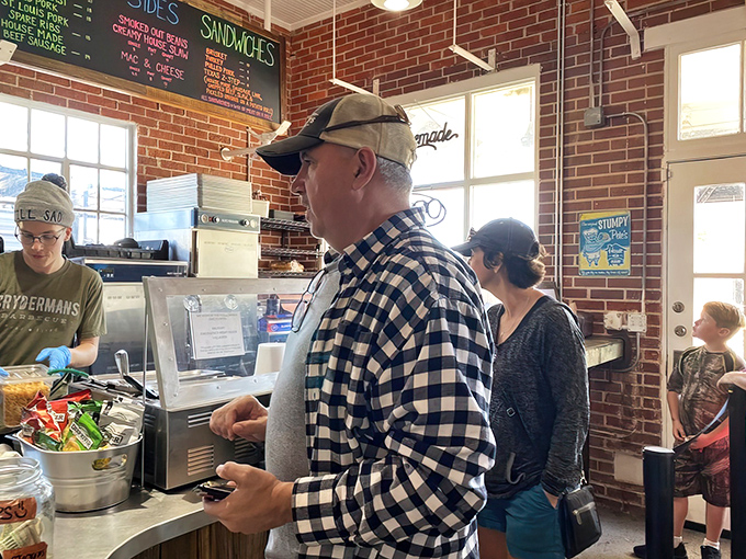 The line forms to the right, folks. In barbecue culture, waiting patiently is just part of the foreplay before the main event.