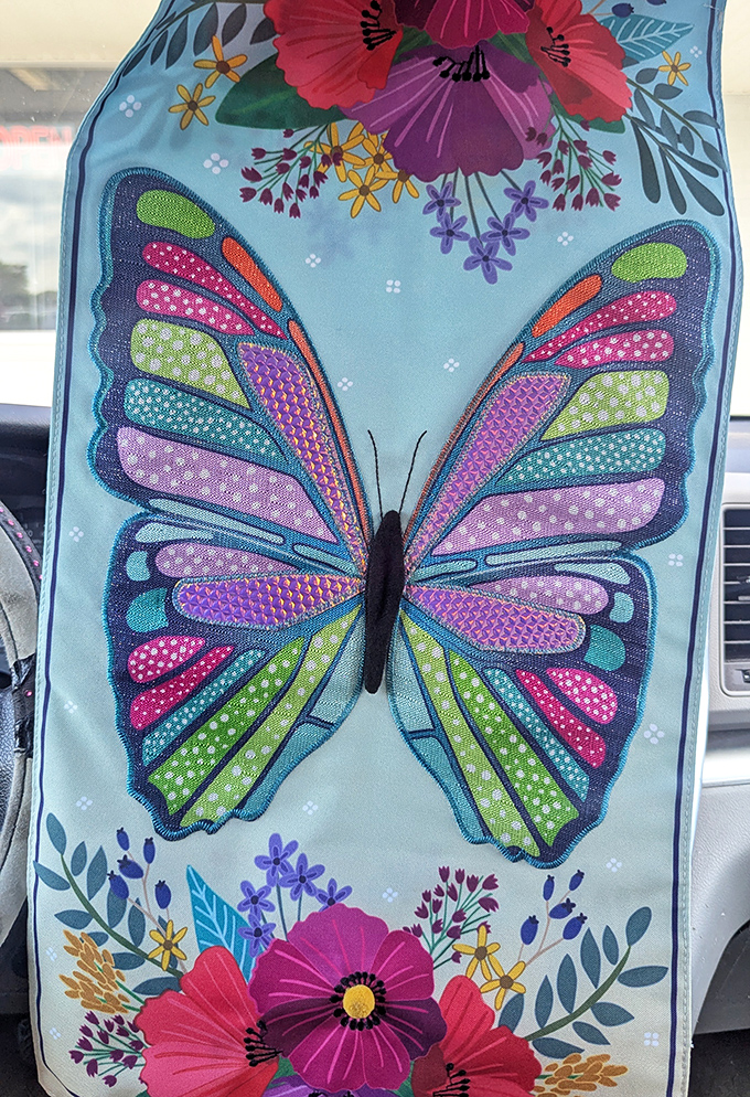 Garden art that transforms mundane spaces into whimsical retreats. This butterfly flag brings more joy per dollar than almost anything else.