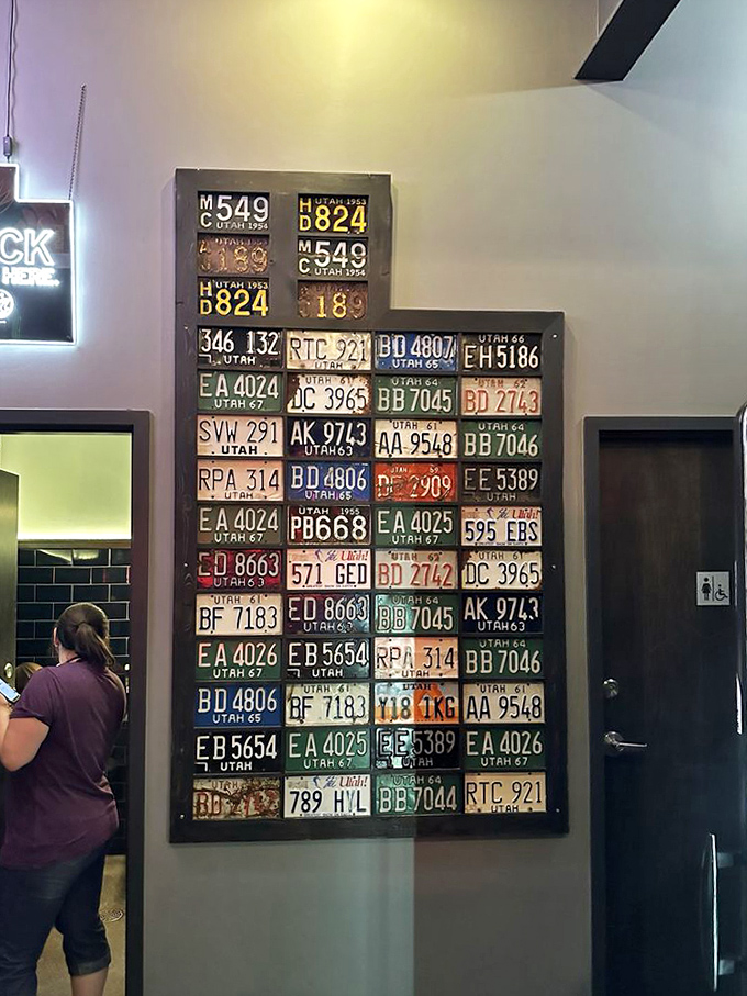 Utah's history displayed through license plates&mdash;a wall that tells stories of road trips, first cars, and the state's journey through the decades.