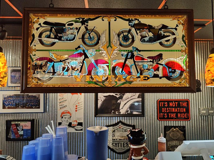 Vintage motorcycle art watches over diners like guardian angels of flavor. "It's not the destination, it's the ride" &ndash; true for both bikes and barbecue journeys.