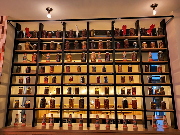 A wall of preserves that would make your grandmother both proud and slightly competitive. Food preservation as modern art.