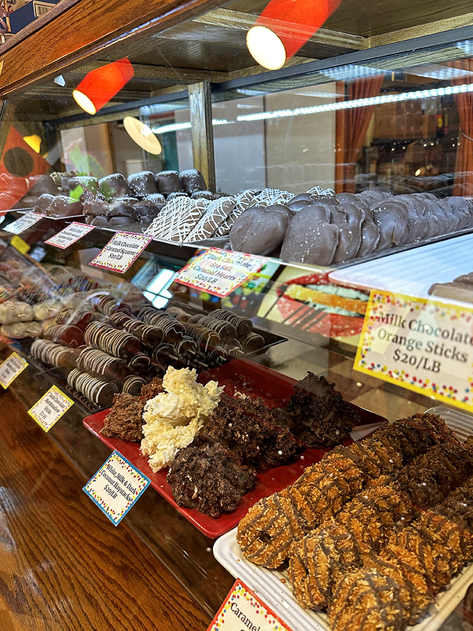 These aren't just display cases—they're treasure chests. Chocolate-dipped delights await behind glass like exhibits in a museum of indulgence.