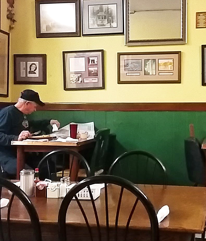 Yellow walls adorned with local history create the perfect backdrop for the morning paper and a plate of something delicious.