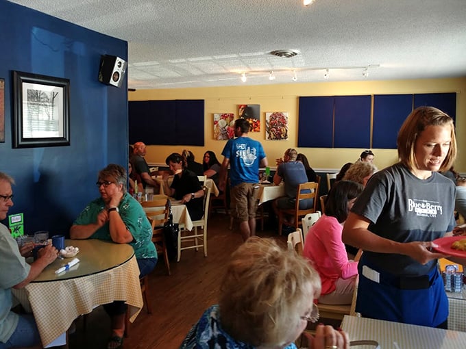 A bustling dining room where strangers become temporary breakfast companions, united by the universal language of "pass the syrup."