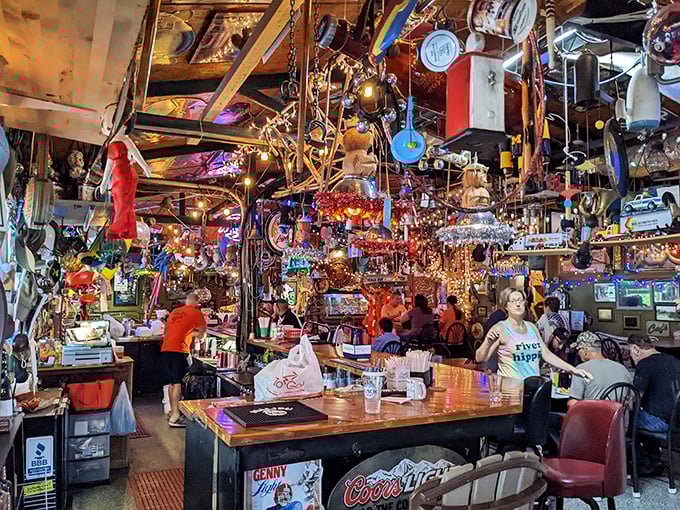 Happy diners surrounded by a kaleidoscope of fishing memorabilia, proving great food tastes even better in surreal surroundings.