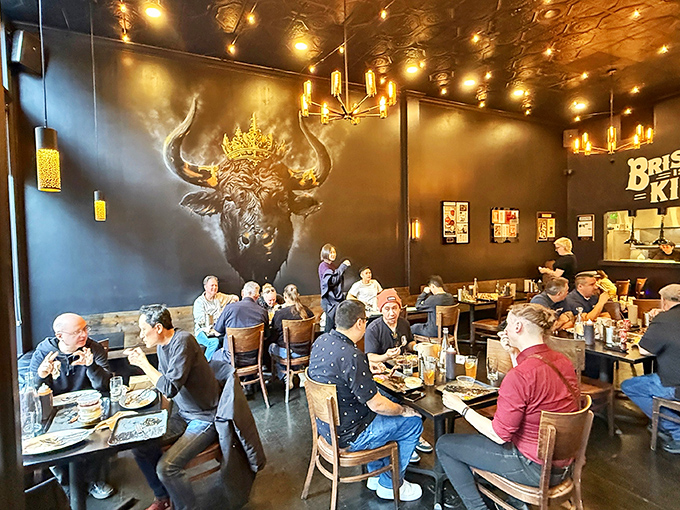 A full house of diners under the watchful gaze of a crowned longhorn&mdash;everyone united in the universal language of "mmmmm."