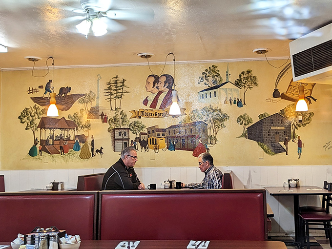 Where strangers become neighbors over coffee and conversation, with local history literally painted on the walls behind them.