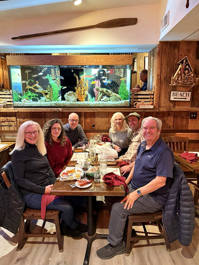 The true measure of a great restaurant: happy diners sharing stories while an aquarium in the background shows tomorrow's special.