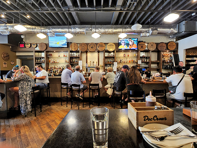 The bar buzzes with conversation and clinking glasses. This is where strangers become friends over shared plates and bourbon tales.