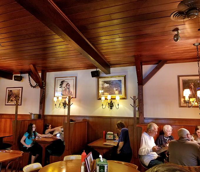 Wooden walls, beamed ceilings, and Western artwork create an atmosphere where stories flow as freely as the wine.