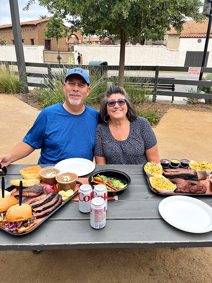 Happy diners with a spread that would make Henry VIII jealous. The table groans with pleasure under this barbecue bounty.