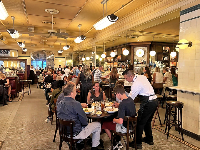 A bustling dining room where memories are made between bites. The waitstaff navigates the space like Olympic skaters&mdash;graceful, purposeful, and never dropping a plate.