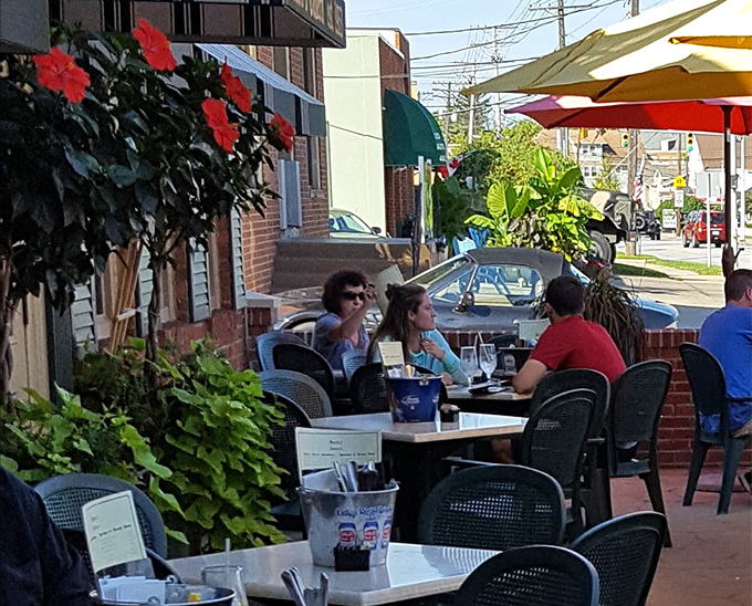 The patio scene &ndash; where strangers become friends over shared appreciation of good food, cold drinks, and the simple pleasure of dining outdoors.