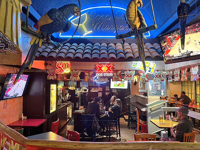 Beer signs glow like beacons of hope in this cozy corner where strangers become friends over shared baskets of tortilla chips.