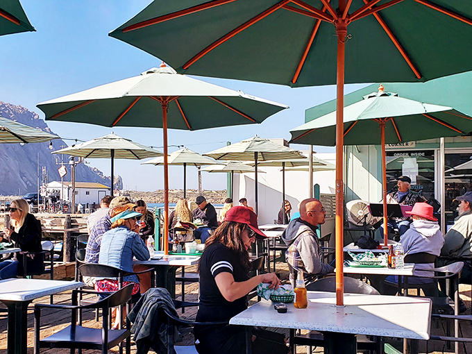 Under a canopy of umbrellas, diners become part of the harbor scene&mdash;half restaurant patio, half impromptu community gathering.