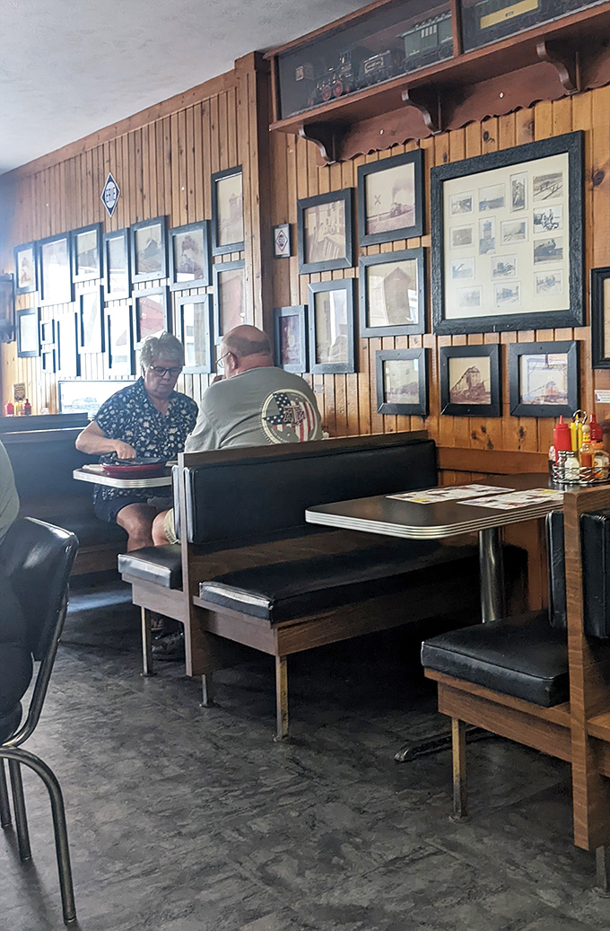 Two regulars sharing stories over plates of comfort food. The wood-paneled walls lined with history make every meal feel like you're dining inside a time capsule.