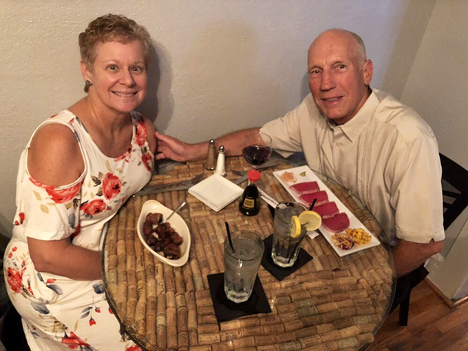 Happy diners enjoying the fruits of Oscar Penn's culinary labor &ndash; where every cork-topped table holds the promise of memorable meals.