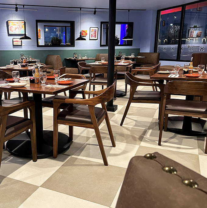 Wooden chairs and checkered floors create a dining room that feels both contemporary and timeless&mdash;like comfort food reimagined for today.