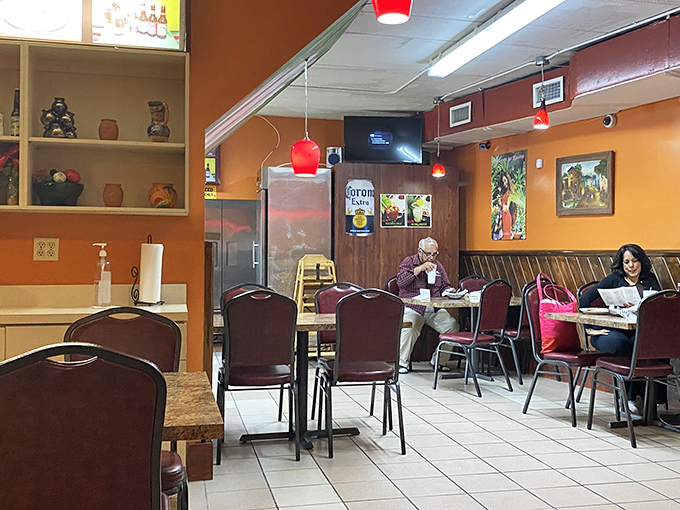 Another view of the dining room reveals the restaurant's homey charm &ndash; where red pendant lights cast a warm glow over satisfied diners.