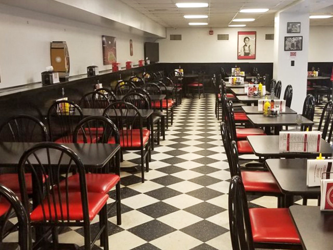 The dining room's checkerboard floor and red accents aren't just design choices&mdash;they're a promise that tradition and quality still matter here.