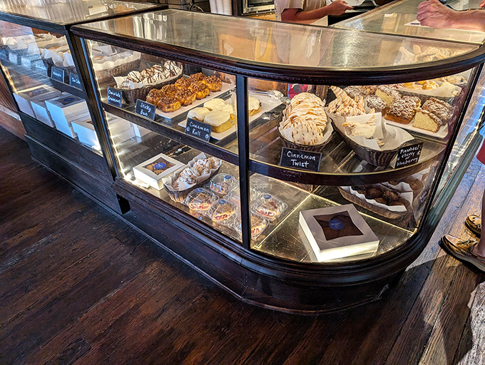 The display case&mdash;a glass-enclosed museum of edible art where willpower goes to die. Each shelf a new temptation, each pastry a new possibility.