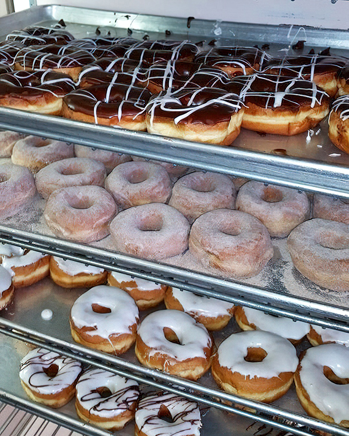 Donut nirvana&mdash;glazed, powdered, and chocolate-drizzled circles of joy stacked with the precision of a Swiss watchmaker.