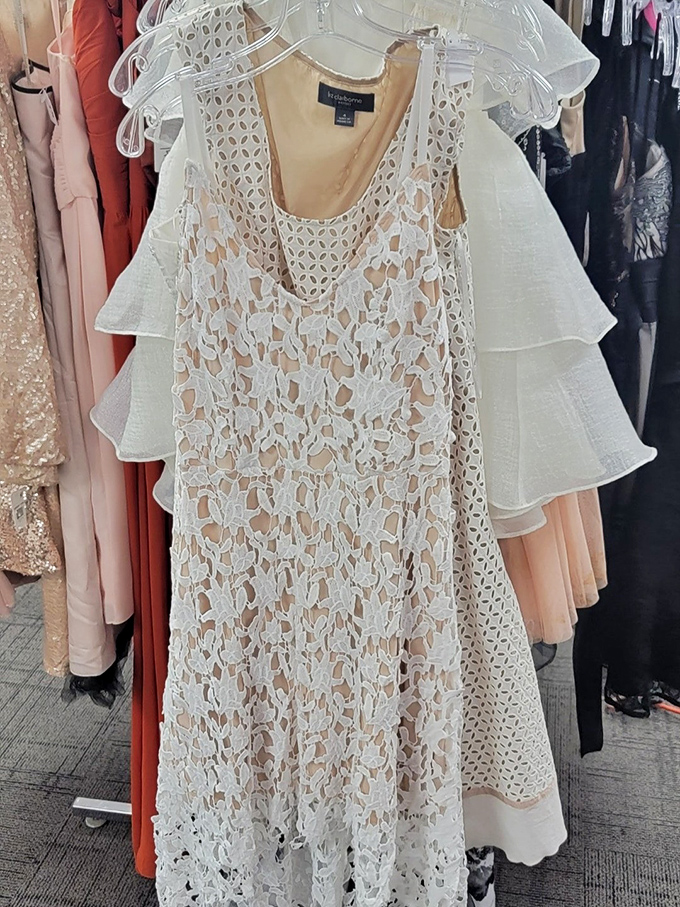 Lace dresses hang like ghosts of special occasions past. Someone's once-worn wedding guest attire becomes another's statement piece at a fraction of retail.