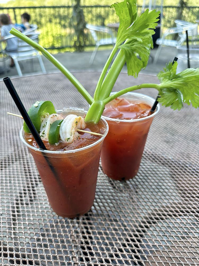 These Bloody Marys aren't just drinks; they're garden-topped masterpieces that serve as both beverage and appetizer in one glorious glass.