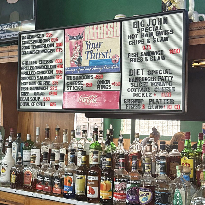 Behind every great burger joint is a well-stocked bar. The vintage Coca-Cola sign reminds us that some pleasures never go out of style.