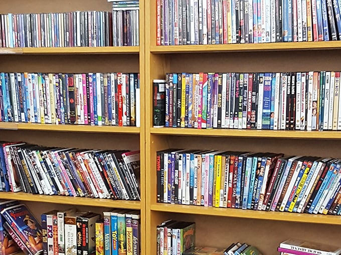 DVD shelves packed tighter than a Netflix server&mdash;proof that physical media collectors still exist and thrive in this digital streaming age.