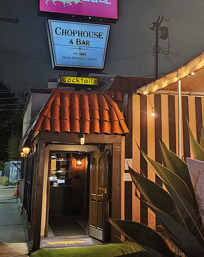 By night, the Golden Bull's entrance glows with promise, like a lighthouse guiding hungry souls to safe harbor.