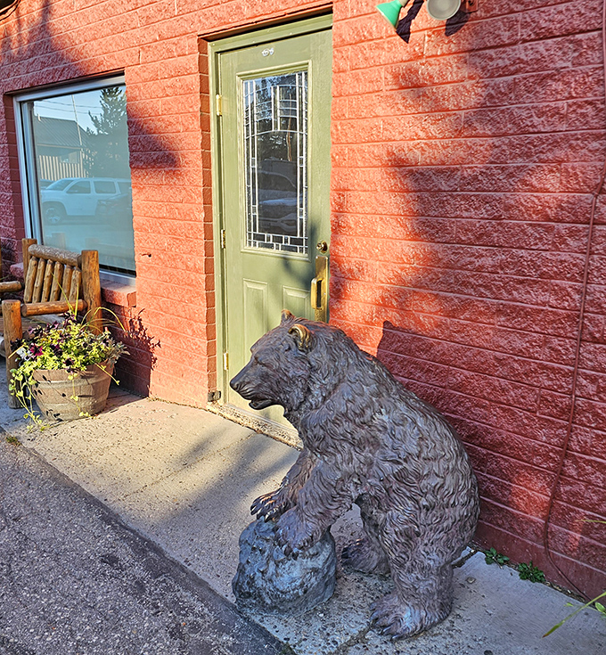 A mint-green door provides a pop of color against the rustic red exterior, welcoming hungry travelers to breakfast paradise.