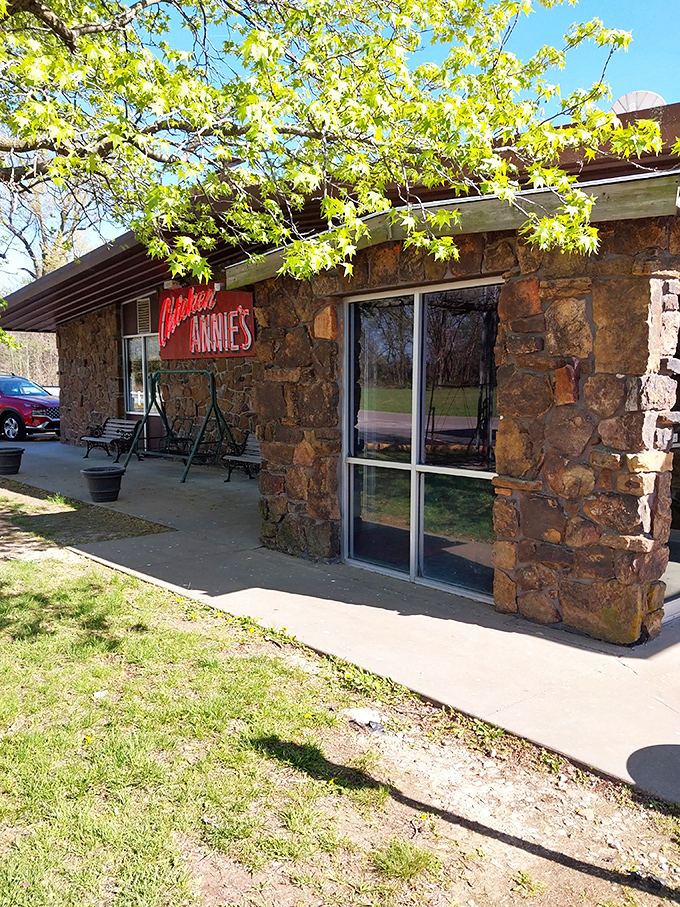 Spring sunshine bathes the entrance in golden light, as if nature itself is highlighting the pathway to some of Kansas's most celebrated fried chicken.