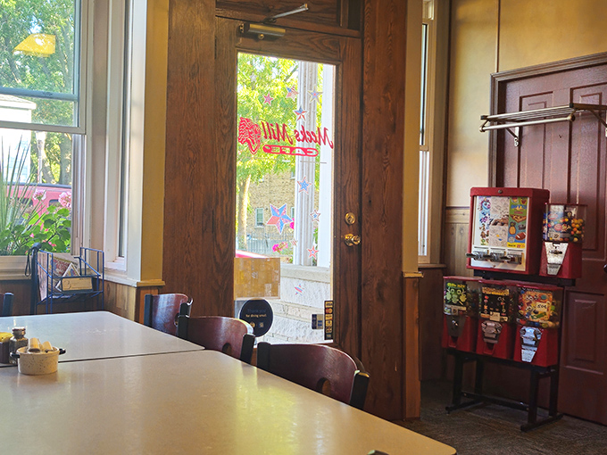 Sunlight streams through the entryway, illuminating simple tables where countless conversations and meals have been shared.