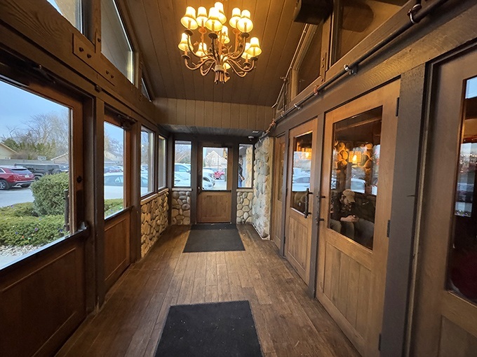 The entryway sets the tone with warm wood and stone that whispers "stay awhile."